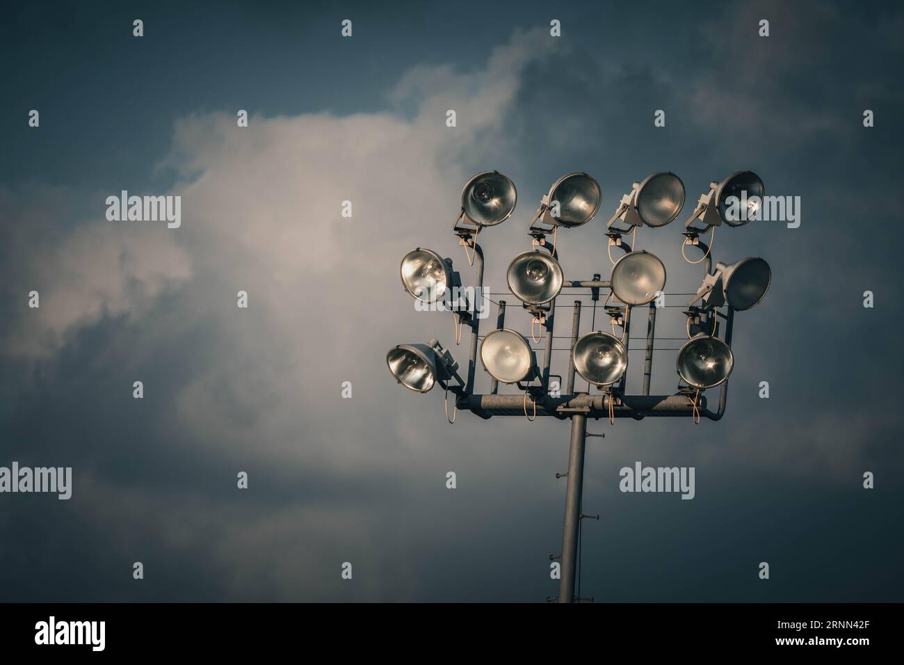 the field lights just before they are needed at sunset Stock Photo - Alamy