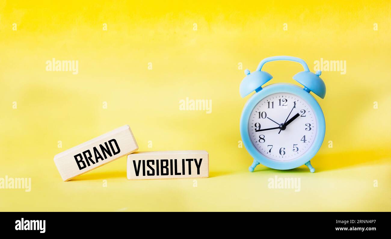 Brand visibility symbol. Wooden blocks with words.Yellow background ...