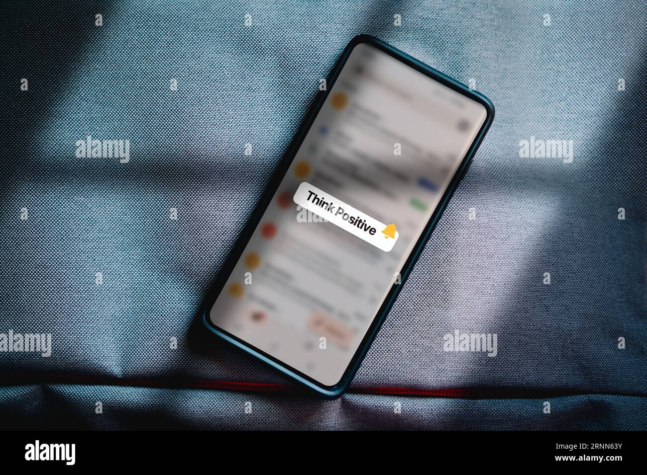 Top view photo of smartphone with "think positive" quote notification ...