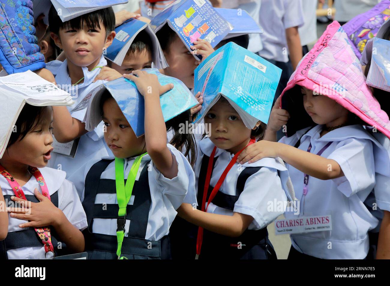 (170629) -- QUEZON CITY, June 29, 2017 -- Students cover their heads ...