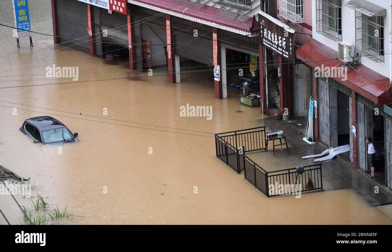 (170630) -- ANHUA, June 30, 2017 -- A car is immersed in flood water in ...