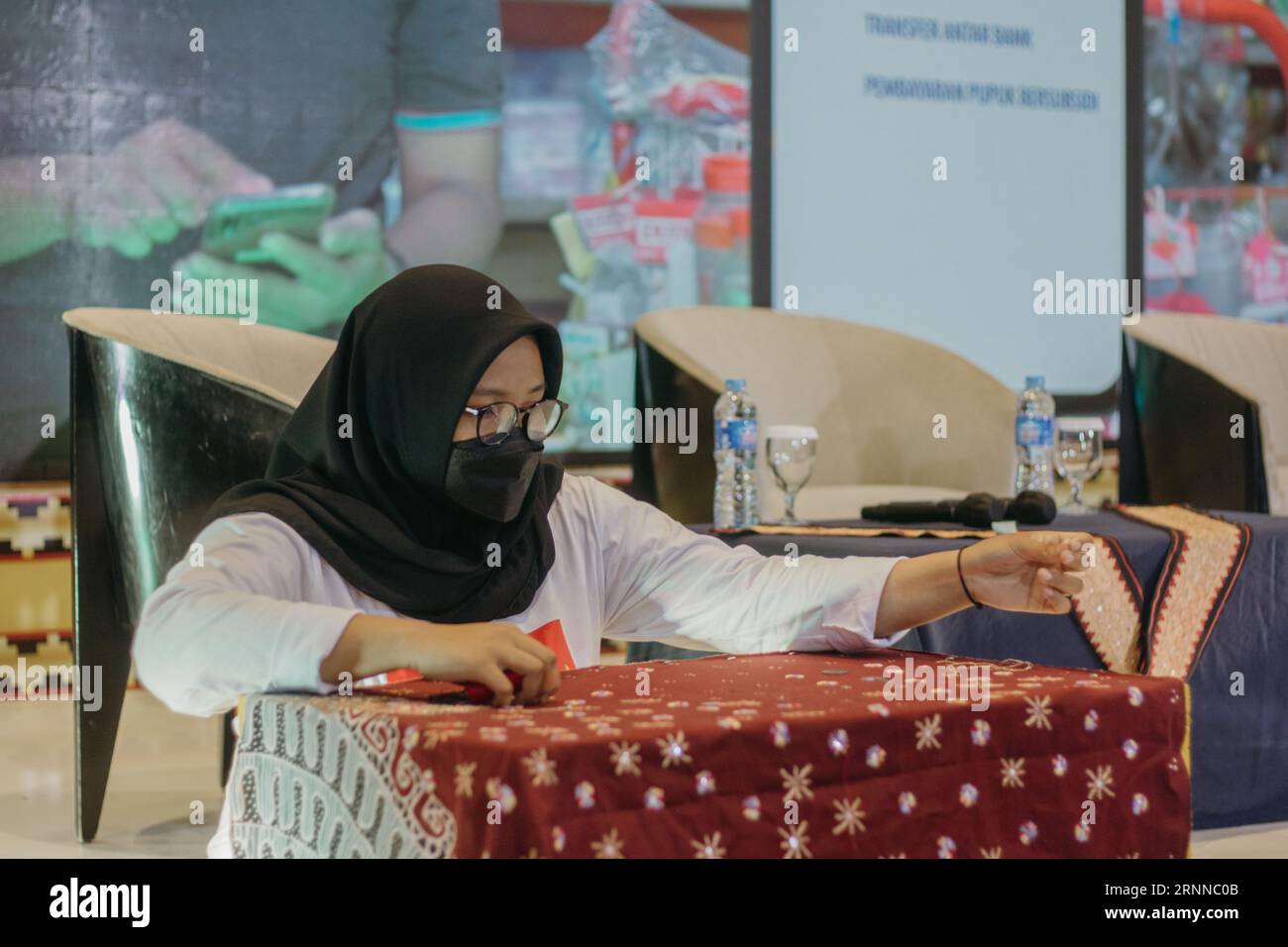 A woman is weaving cloth, or so-called traditional tapis cloth Stock ...