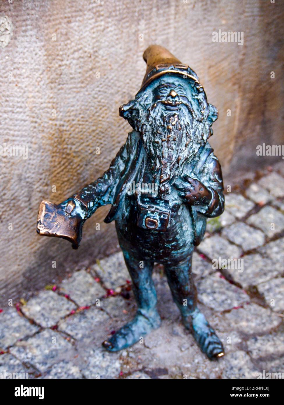 A closeup of a dwarf statue on a cobblestone street in Wroclaw, Poland ...