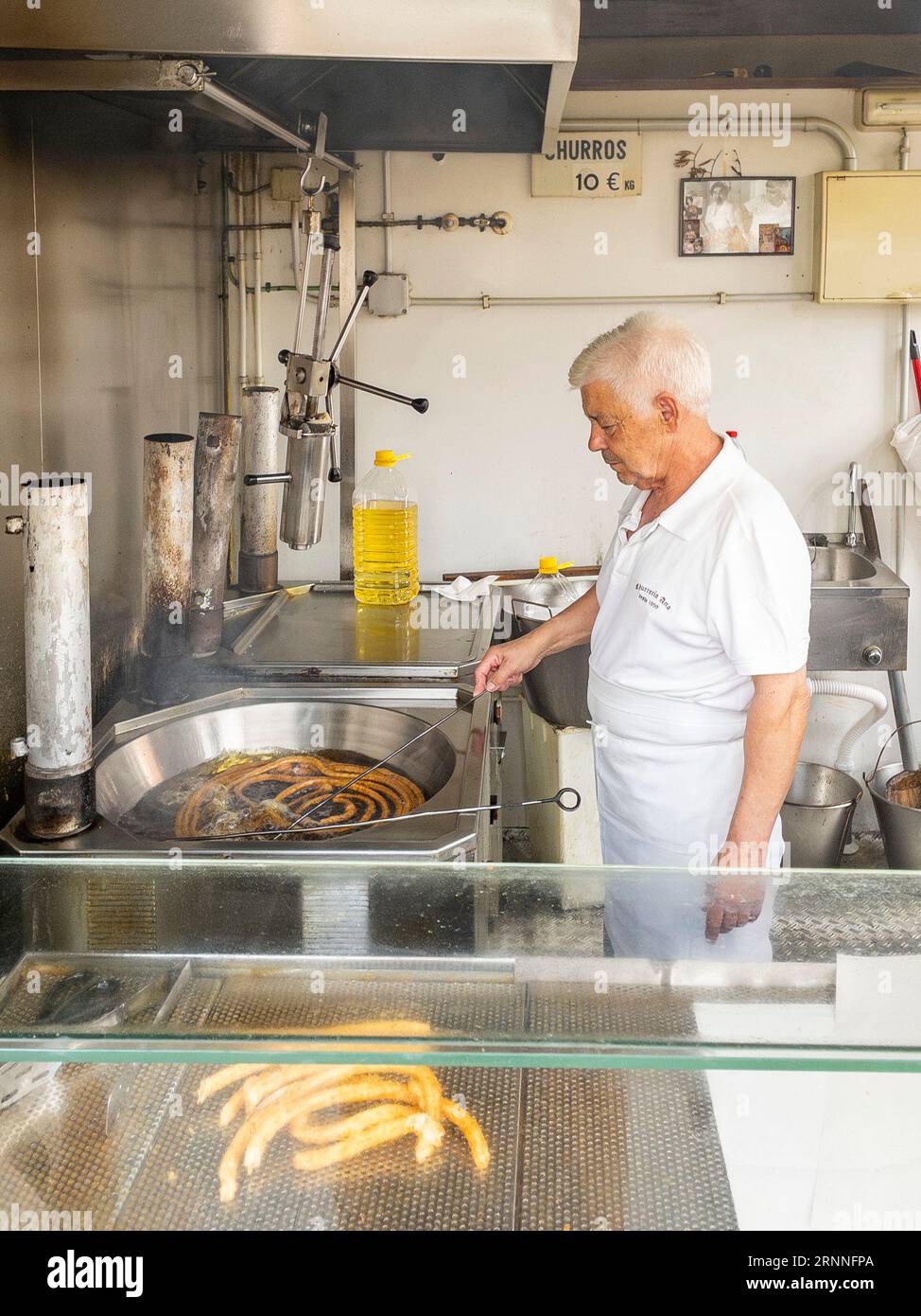 Churrero (churro maker) making churros in Churreria Ana, a kiosk of the ...