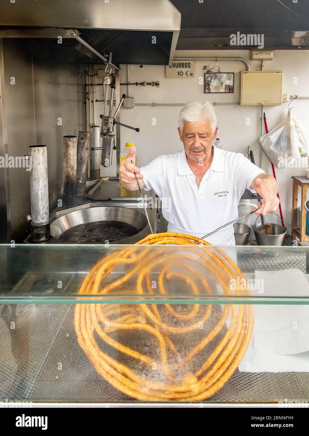 Churrero (churro maker) making churros in Churreria Ana, a kiosk of the ...