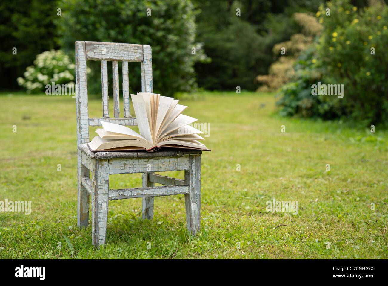 Old book on chair hi-res stock photography and images - Alamy