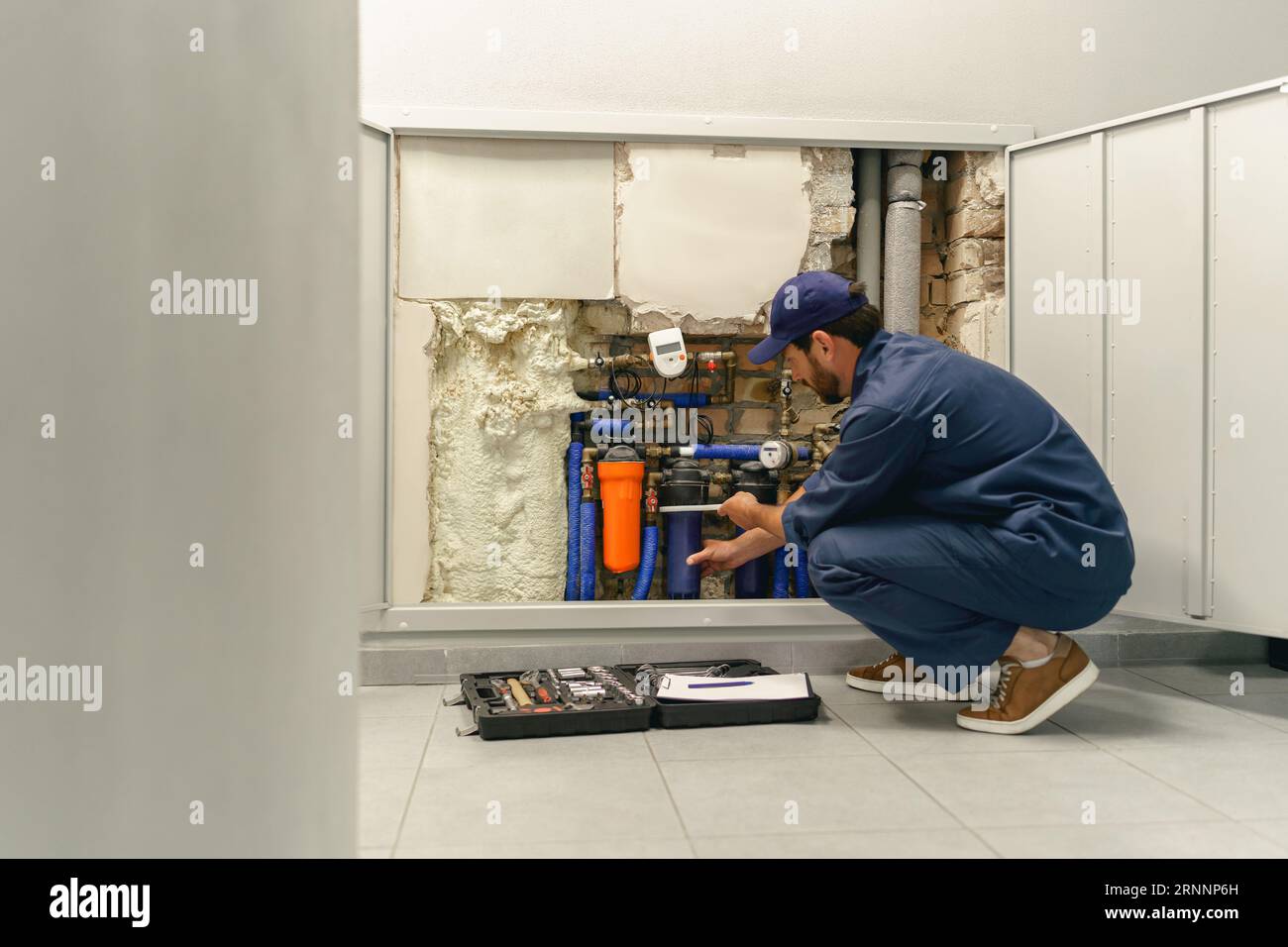 Professional plumber repairing water supply system at home uses a ...