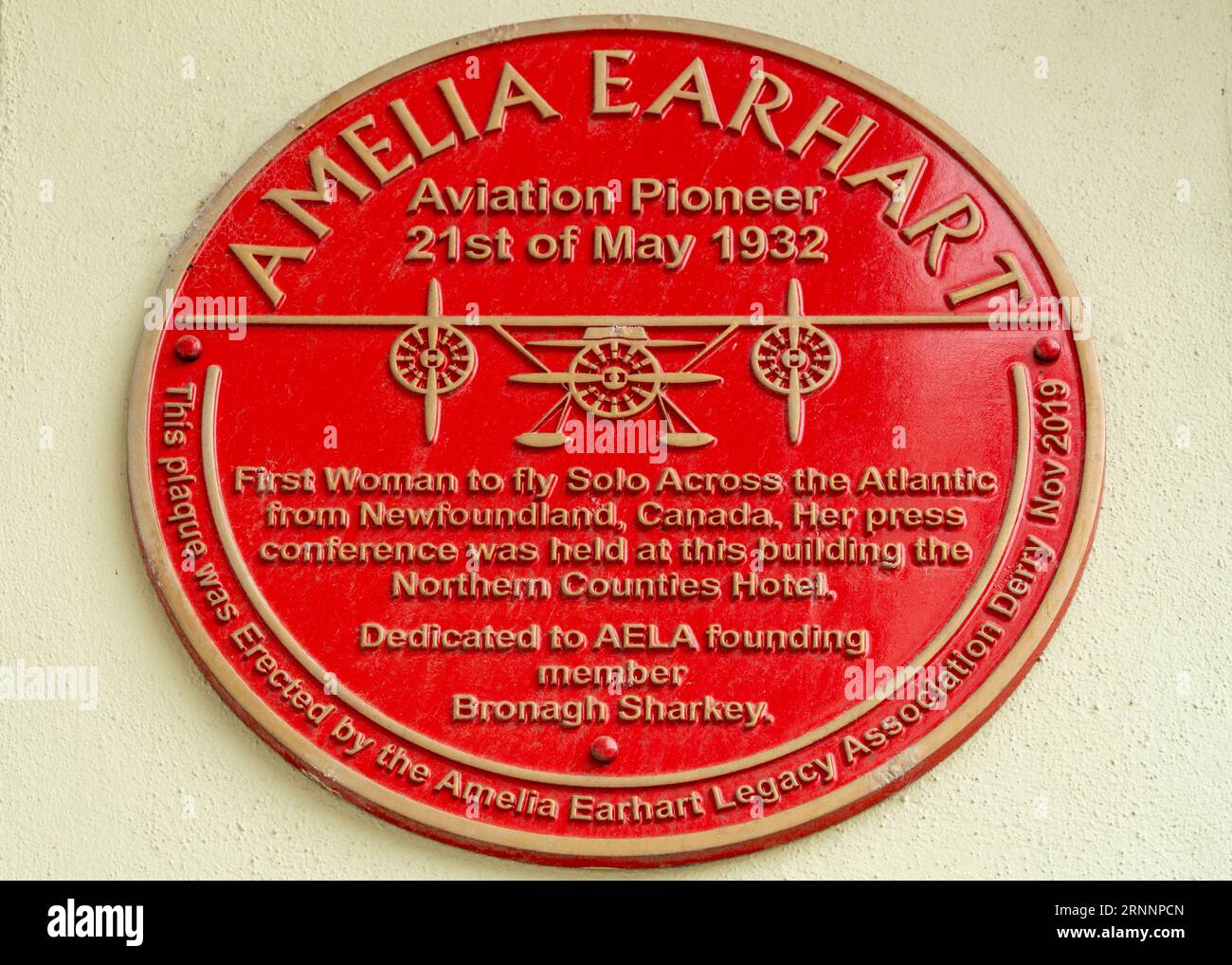 Red plaque commemorating pilot Amelia Earhart, first woman to fly across the Atlantic, Derry ...