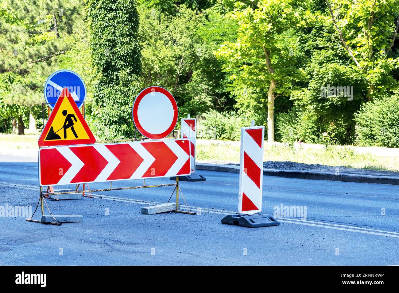 Road signs and the traffic light . Roadworks, road signs in a highway ...