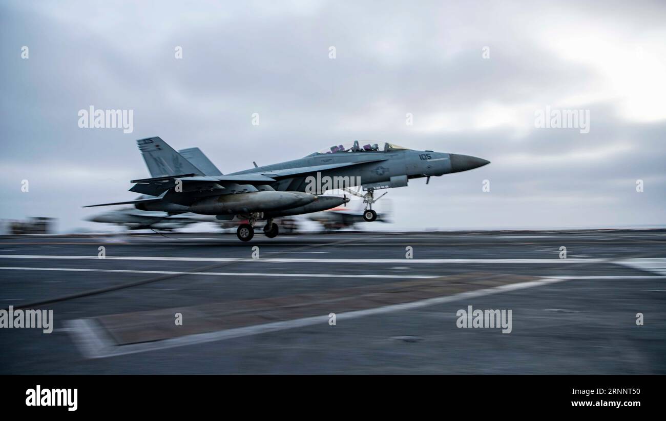 An F/A-18F Super Hornet makes an arrested landing on the flight deck ...