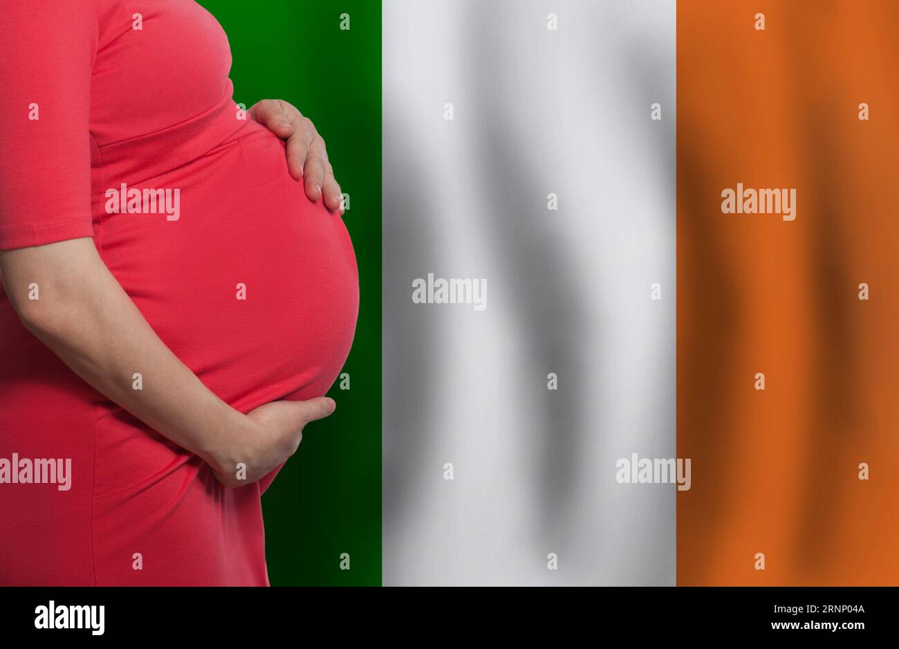 Pregnant woman belly on Irish flag background Stock Photo - Alamy