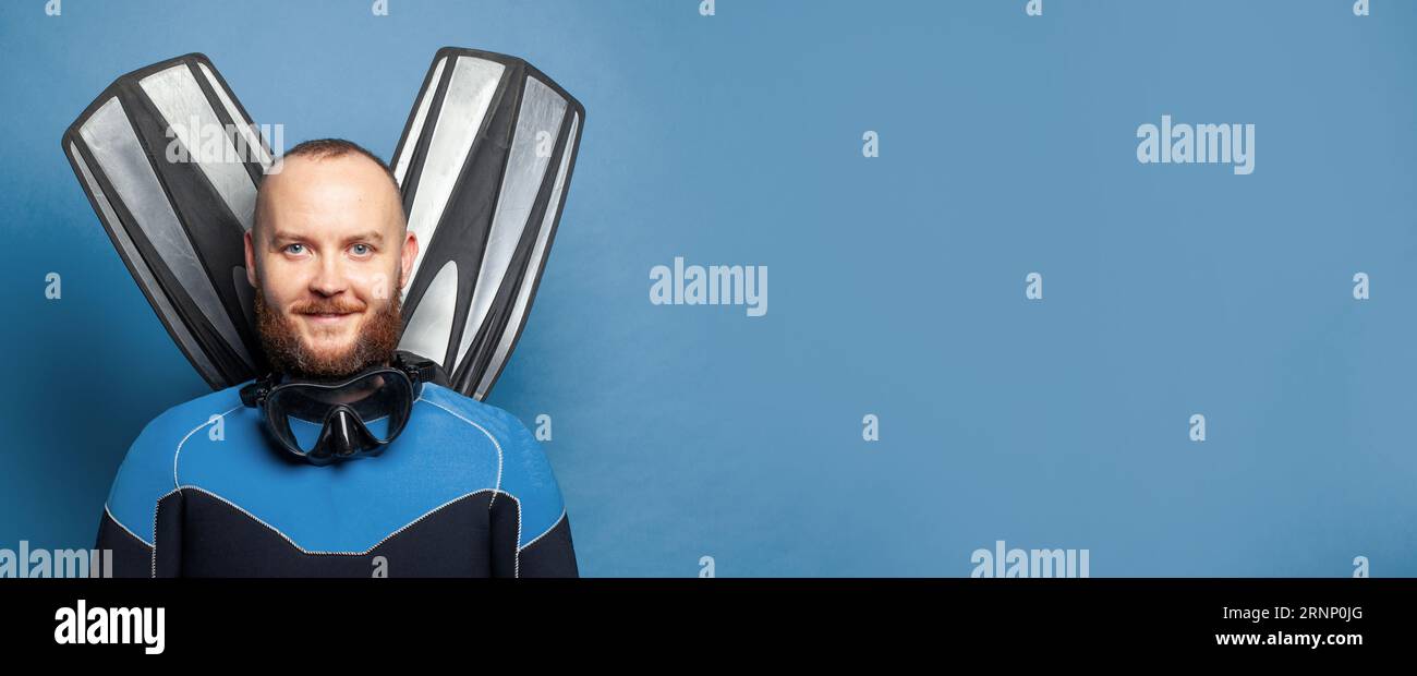 Closeup portrait of handsome diver diving man with flippers against ...