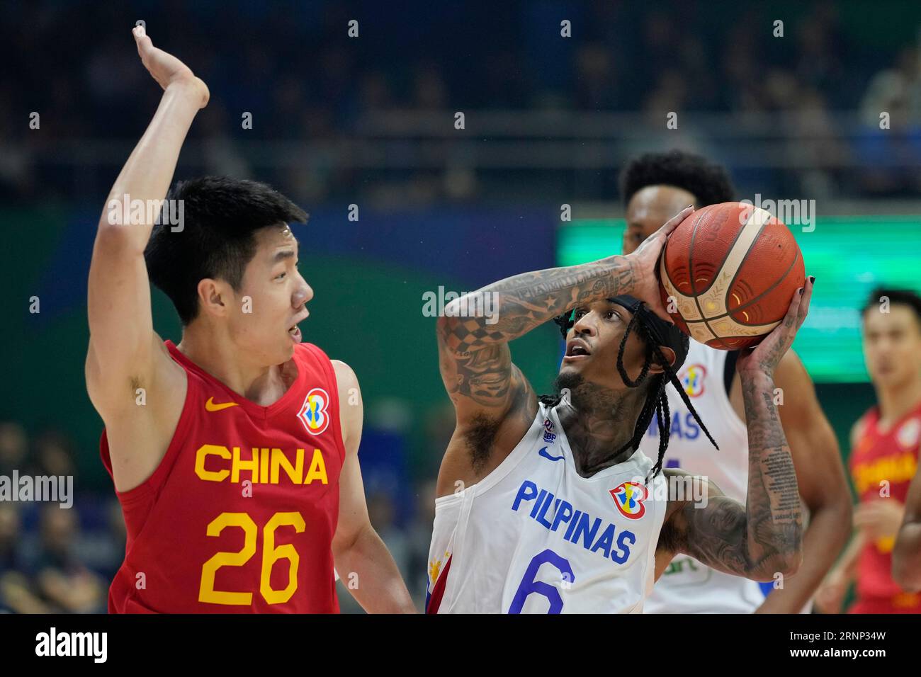 Philippines guard Jordan Clarkson (6) tries to manuever past China forward Zhu Junlong (26 ...