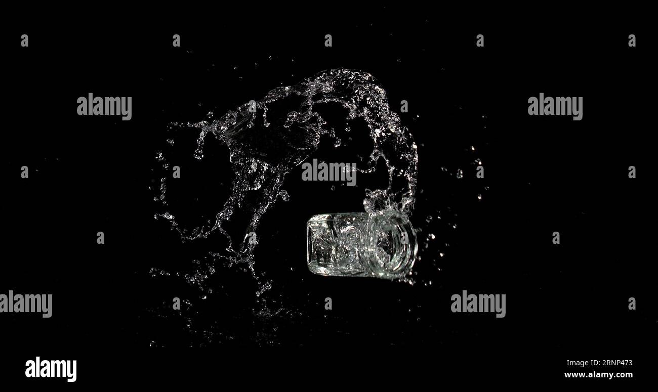 Glass of Water Bouncing and Splashing on Black Background Stock Photo ...