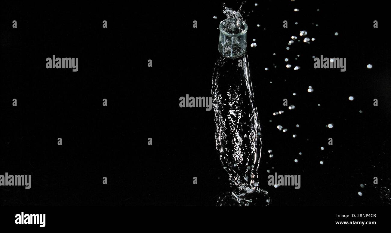 Glass of Water Bouncing and Splashing on Black Background Stock Photo ...
