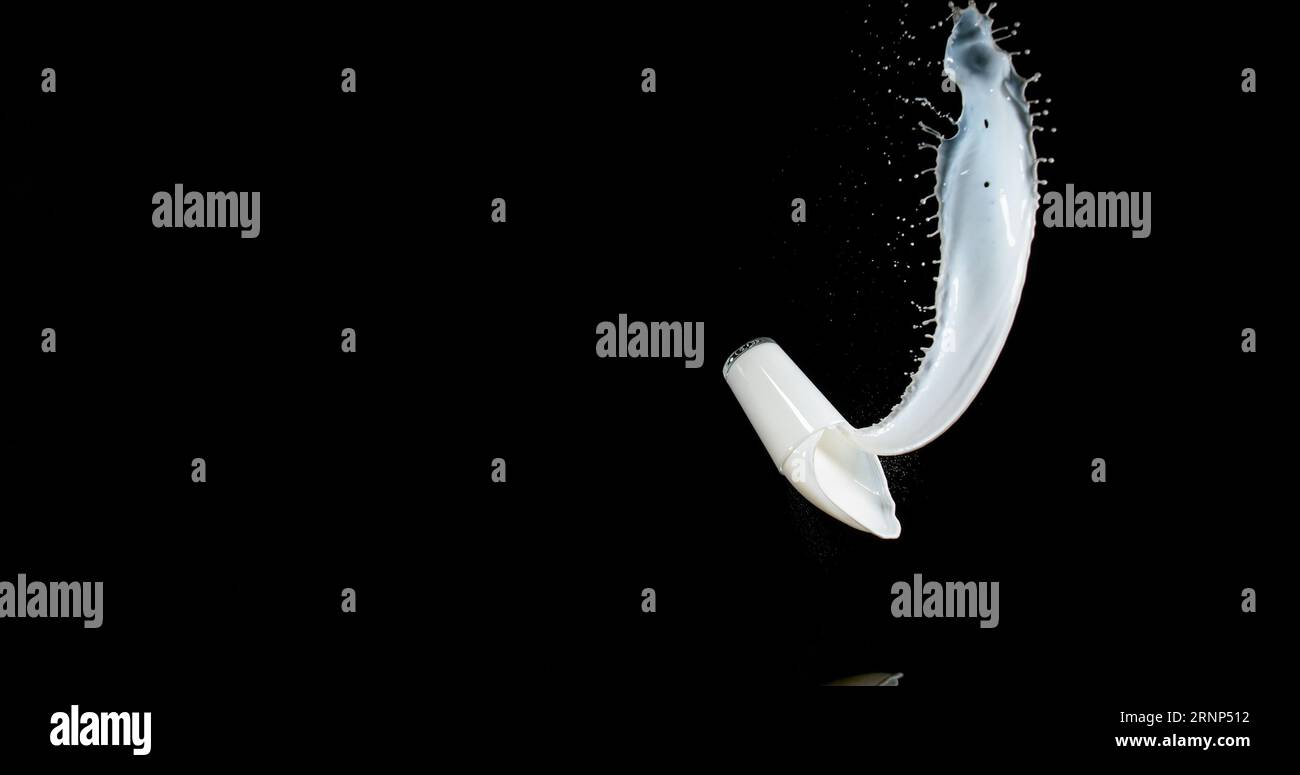 Glass of Milk Bouncing and Splashing on Black Background Stock Photo ...