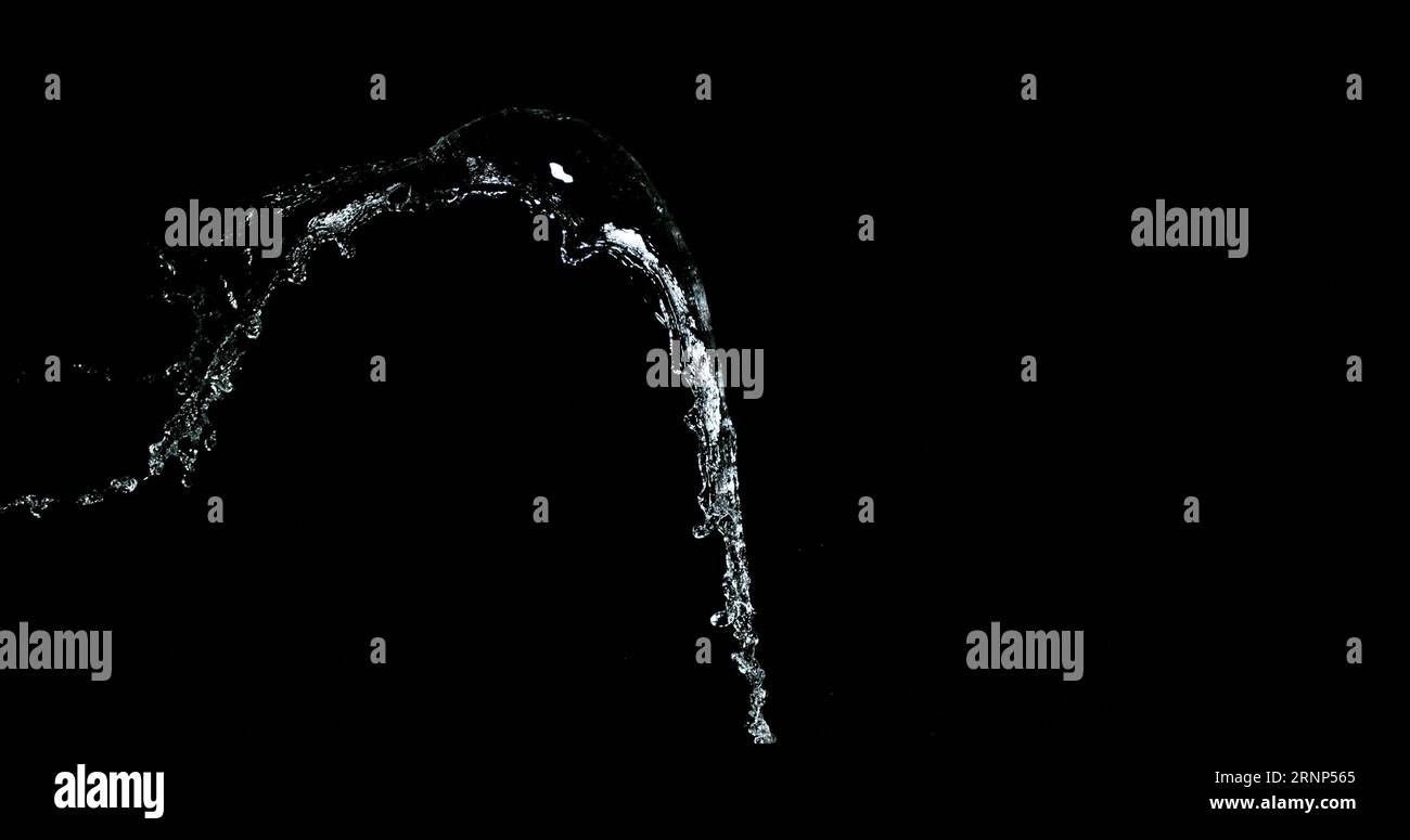 Water spurting out ans Splashing against Black Background Stock Photo ...