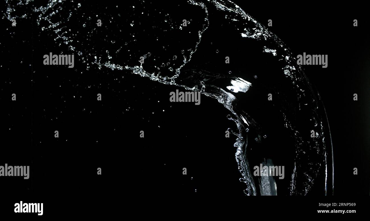 Water spurting out ans Splashing against Black Background Stock Photo ...