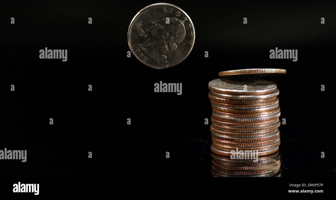 Quarter Dollar Coins Falling, Rolling and Sliding on Black Background ...