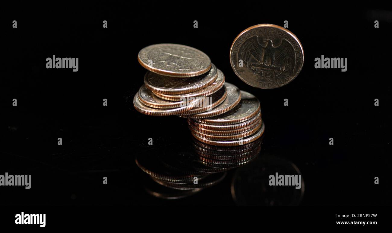 Quarter Dollar Coins Falling, Rolling and Sliding on Black Background ...