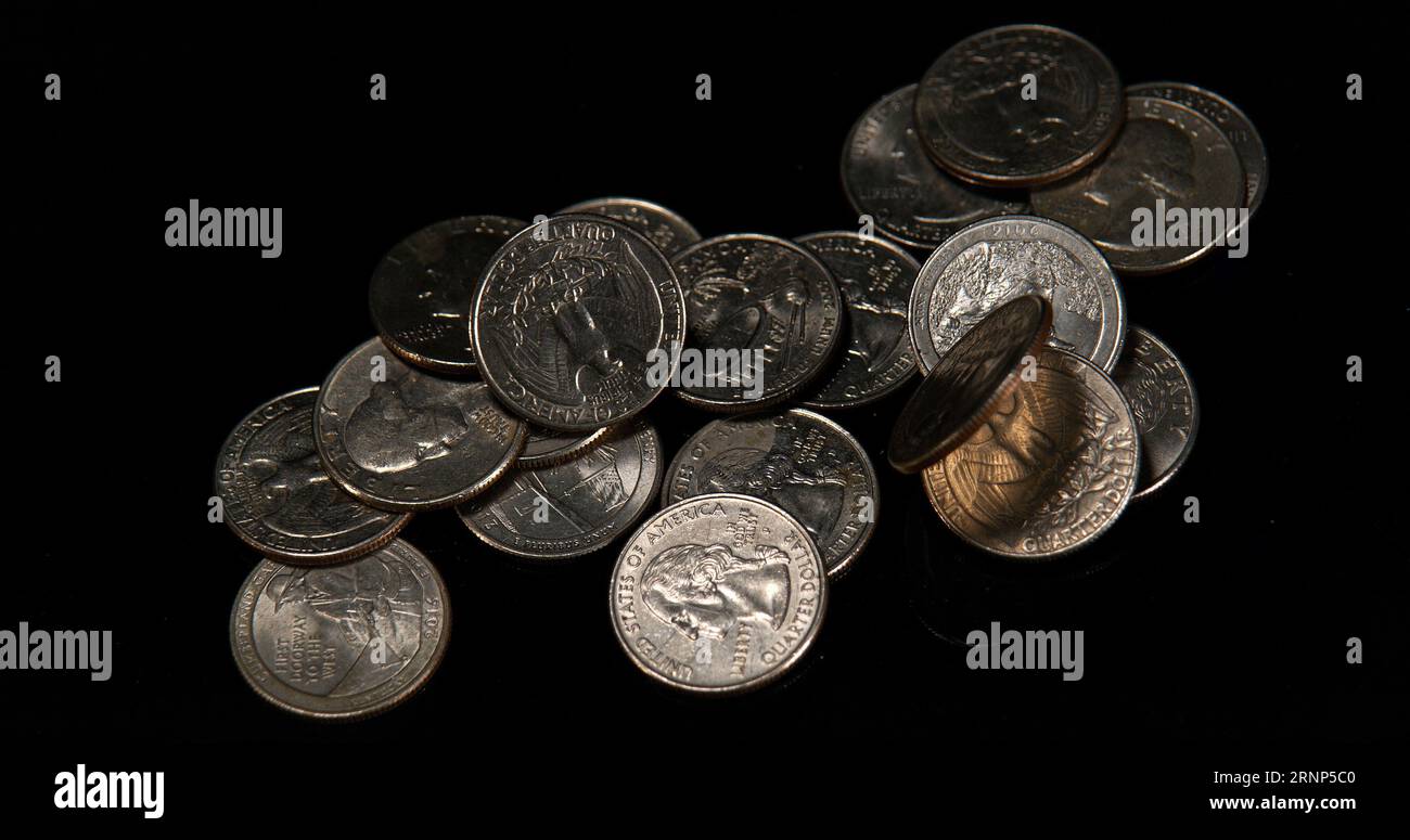Quarter Dollar Coins Falling, Rolling and Sliding on Black Background ...