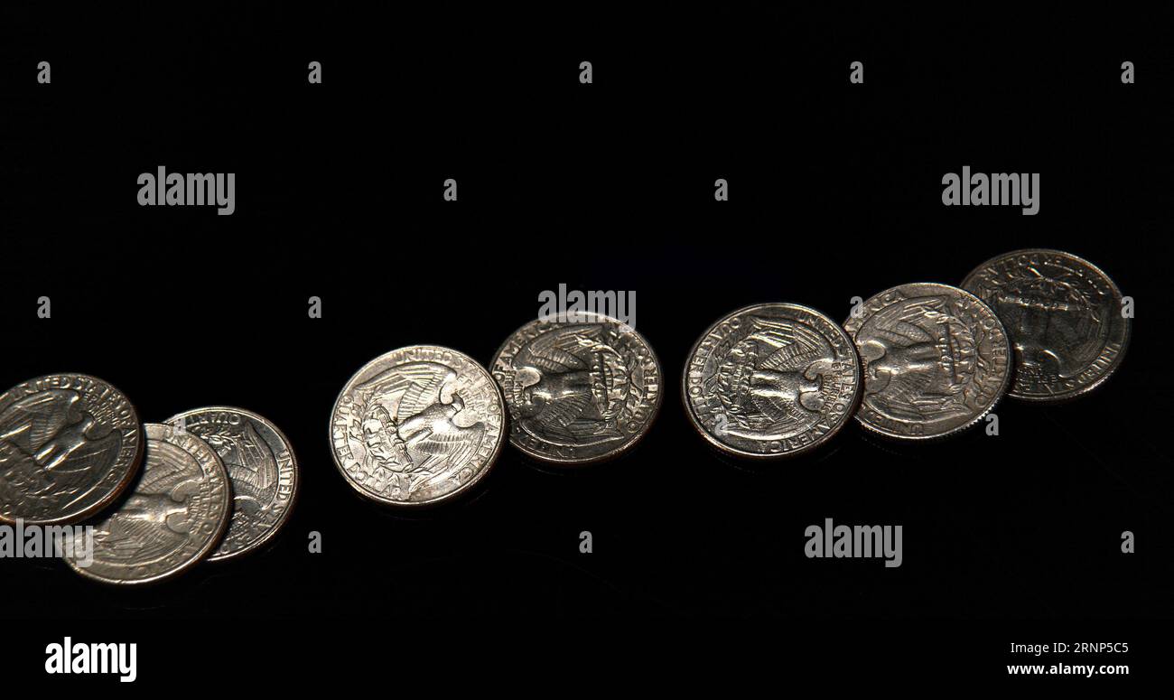 Quarter Dollar Coins Falling, Rolling and Sliding on Black Background ...