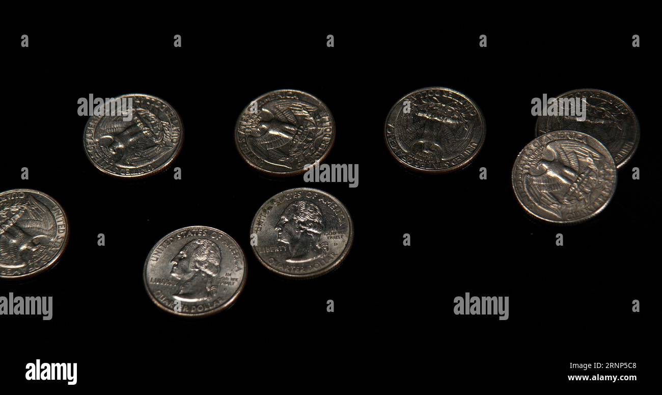 Quarter Dollar Coins Falling, Rolling and Sliding on Black Background ...