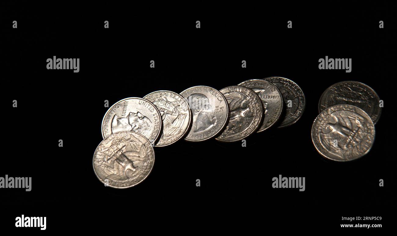 Quarter Dollar Coins Falling, Rolling and Sliding on Black Background ...