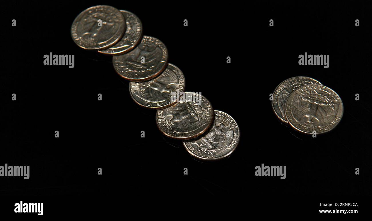 Quarter Dollar Coins Falling, Rolling and Sliding on Black Background ...