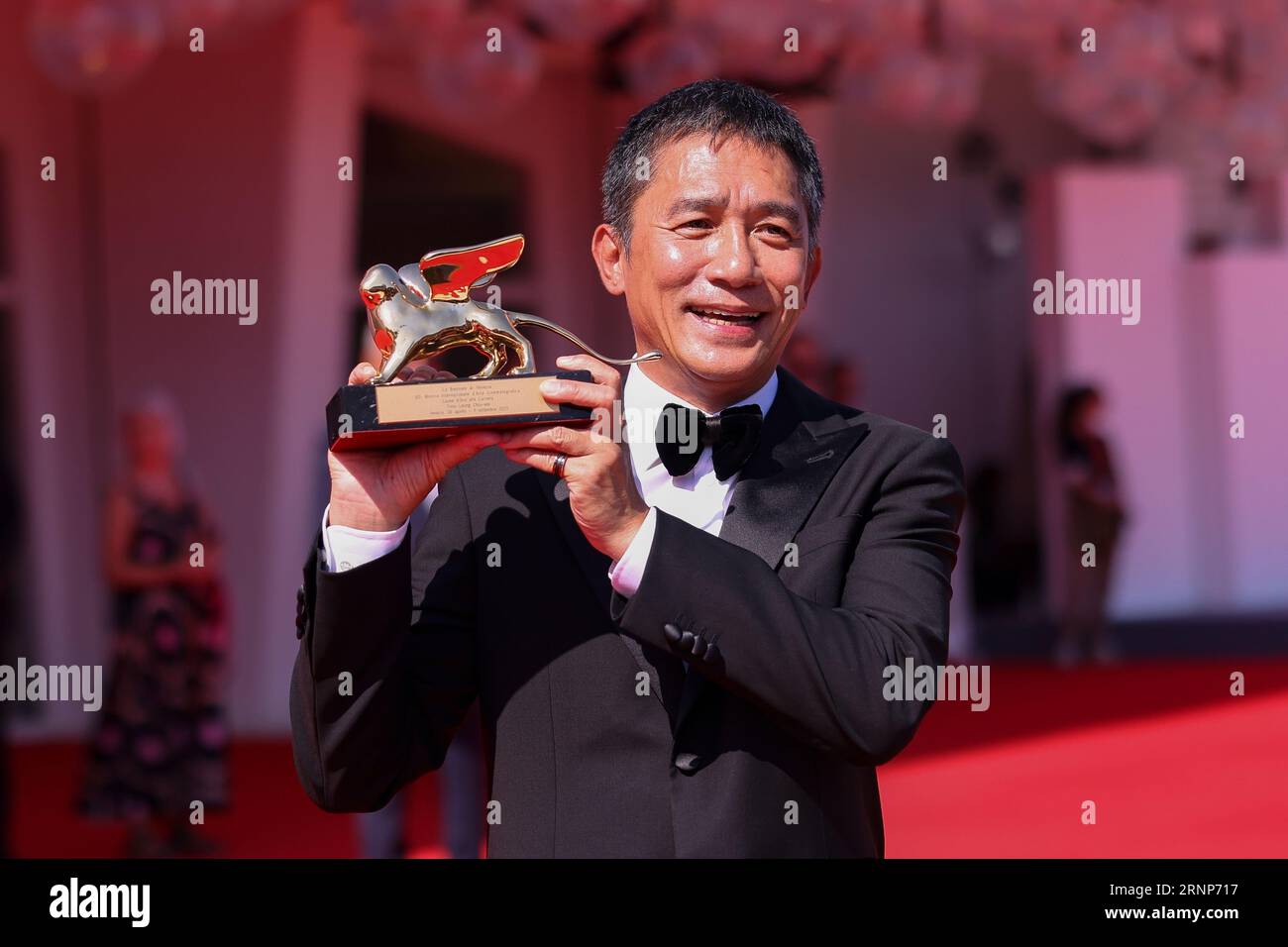 Tony Leung Chiu-wai poses for photographers with the Golden Lion for ...