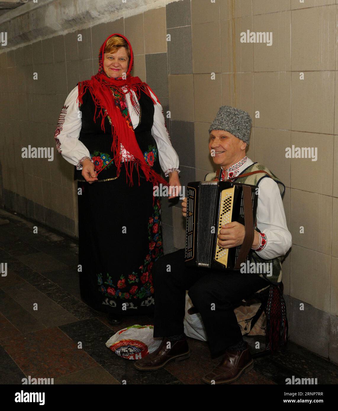 An old man and woman, street musicians, dressed in national Ukrainian ...
