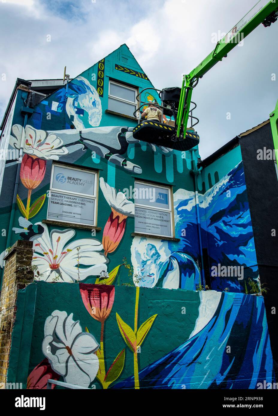 Graffiti artists creating street art pieces at the at the Southend City ...
