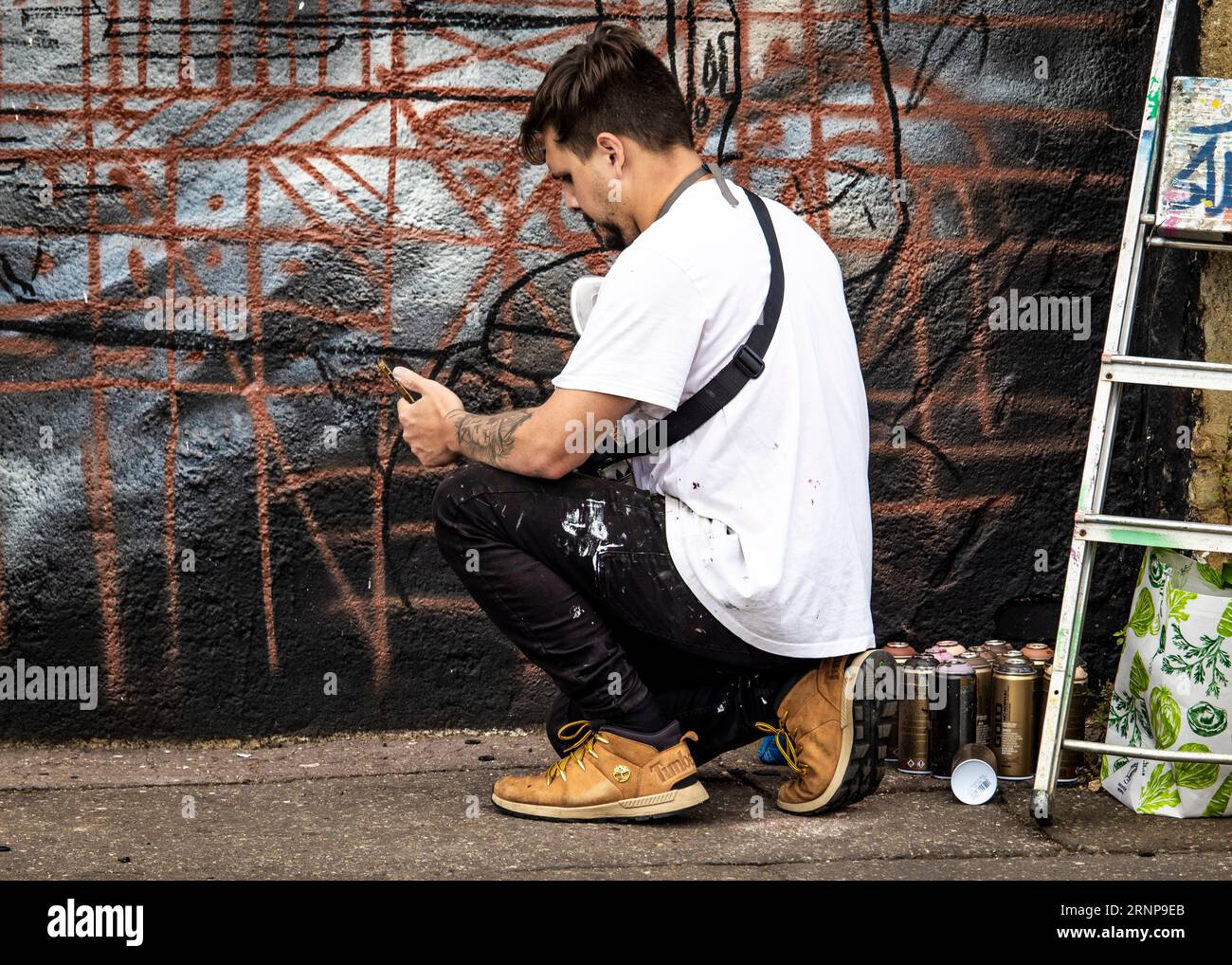 Graffiti artists creating street art pieces at the at the Southend City ...