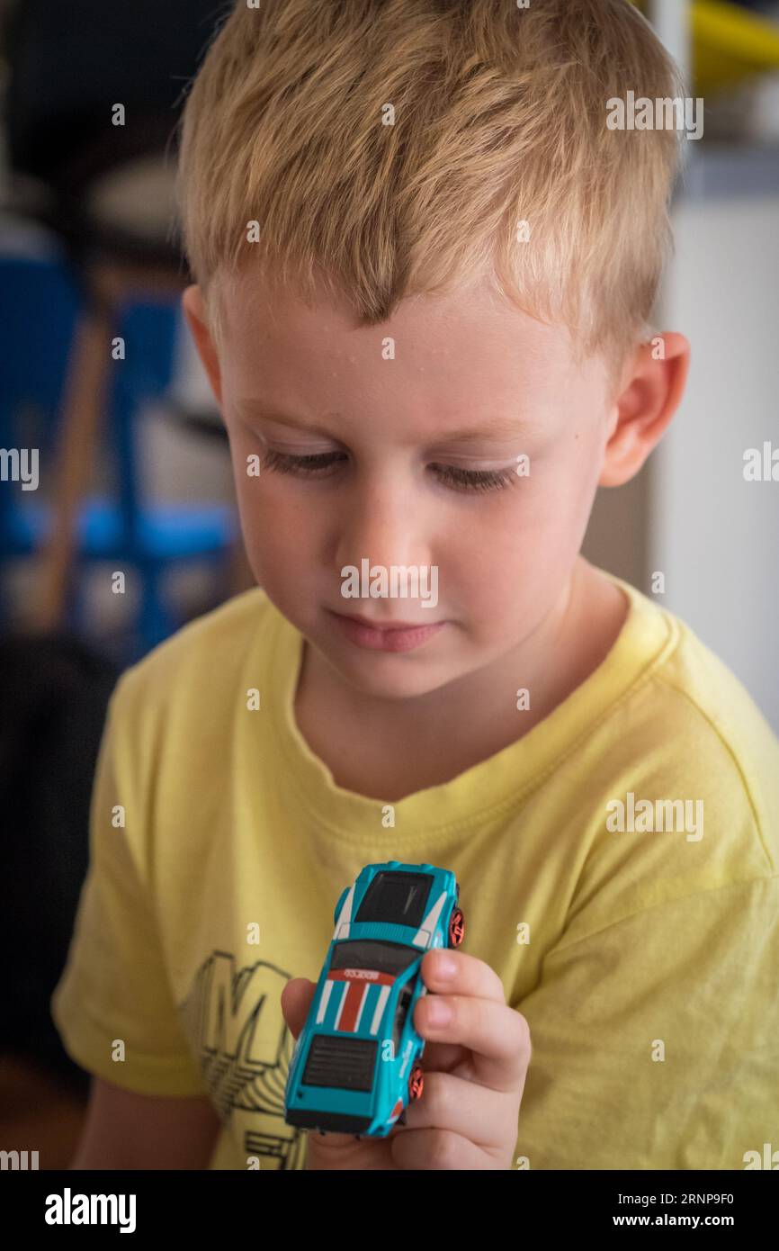 Cute little boy staring and playing with his hot wheel cars Stock Photo ...