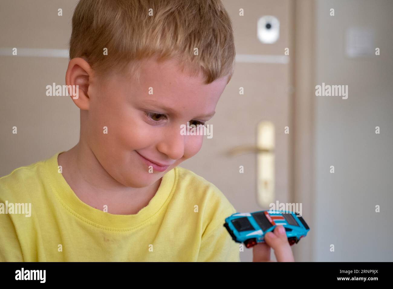 Cute little boy staring and playing with his hot wheel cars Stock Photo ...