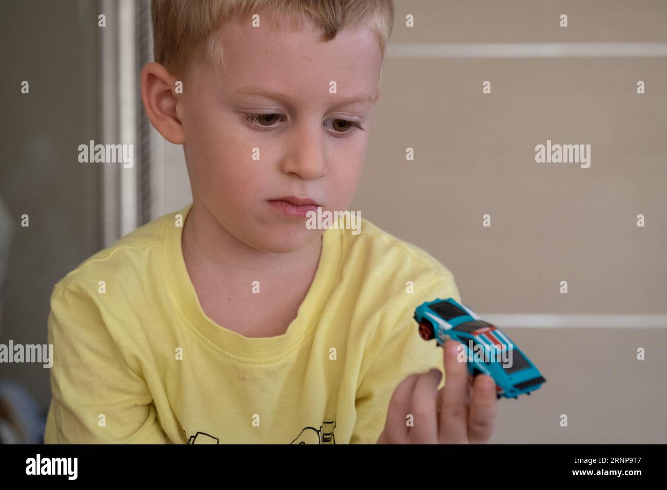 Cute little boy staring and playing with his hot wheel cars Stock Photo ...