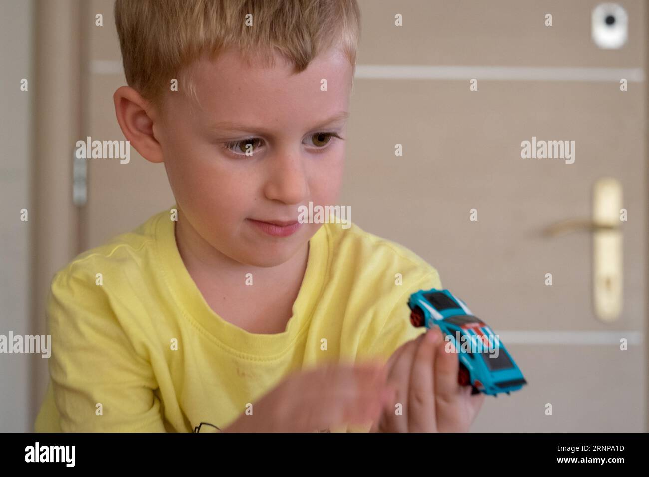 Cute little boy staring and playing with his hot wheel cars Stock Photo ...