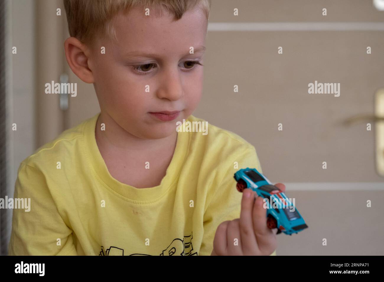 Cute little boy staring and playing with his hot wheel cars Stock Photo ...