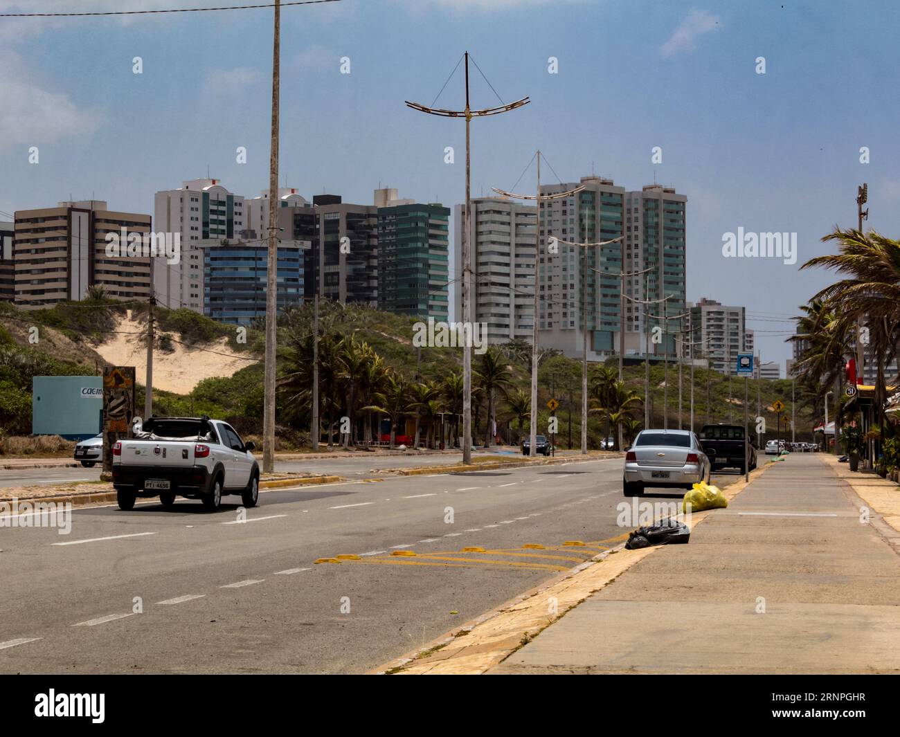 The dunes of Calhau beach, partially covered by native vegetation, and ...