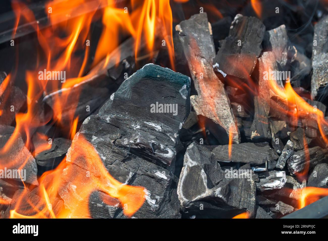 Barbecue grill pit with glowing and flaming hot open fire with red ...