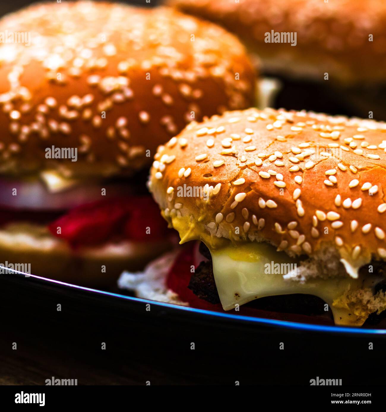 Tasty home made cheeseburger. Cheese burger with pickles, tomatoes ...