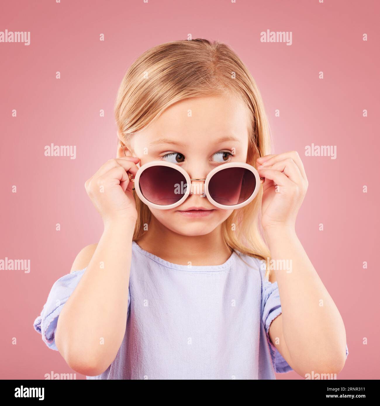 Curious, face and girl child with glasses in studio with news ...