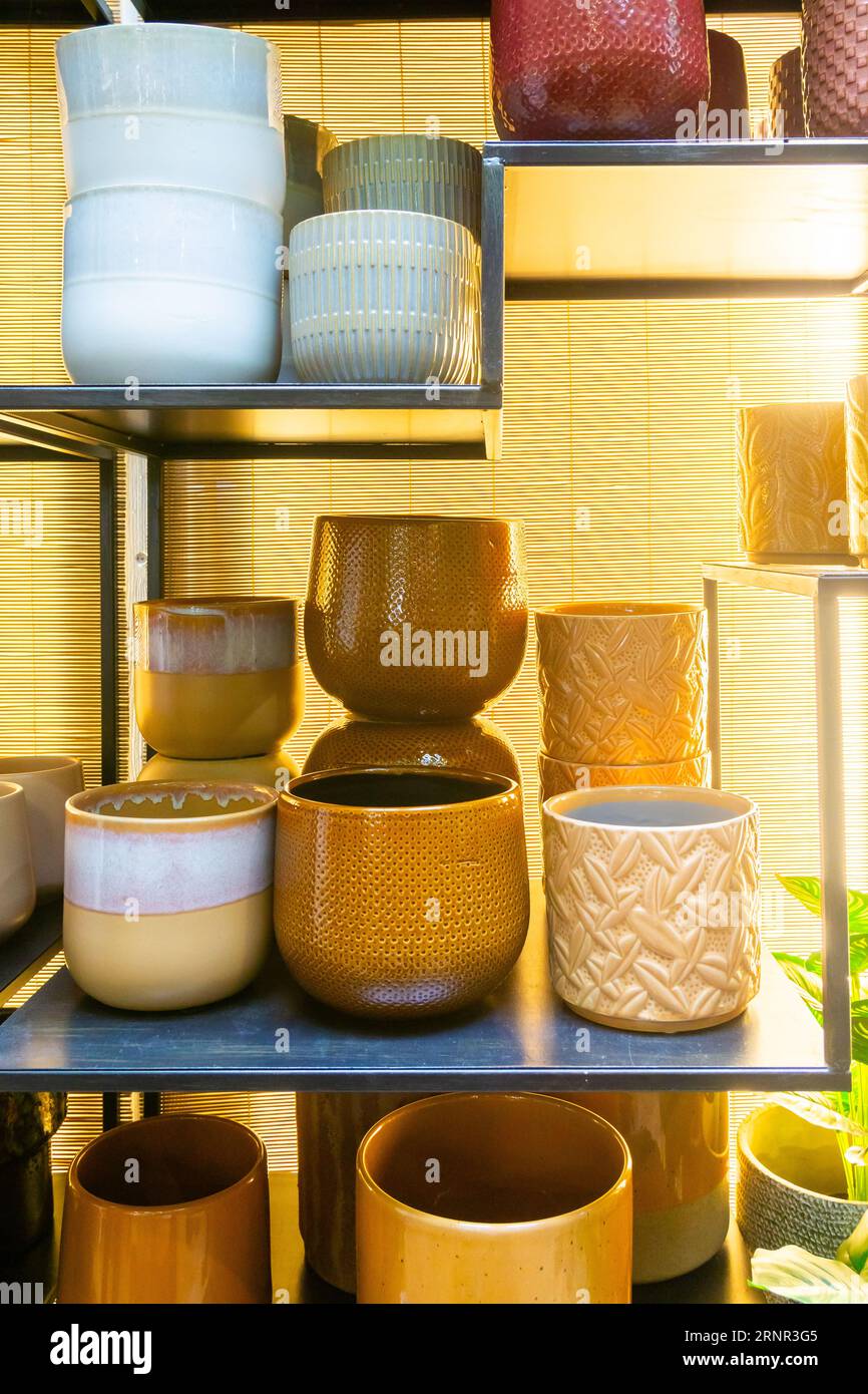 Collection of clay pots in different sizes, colors and textures placed ...