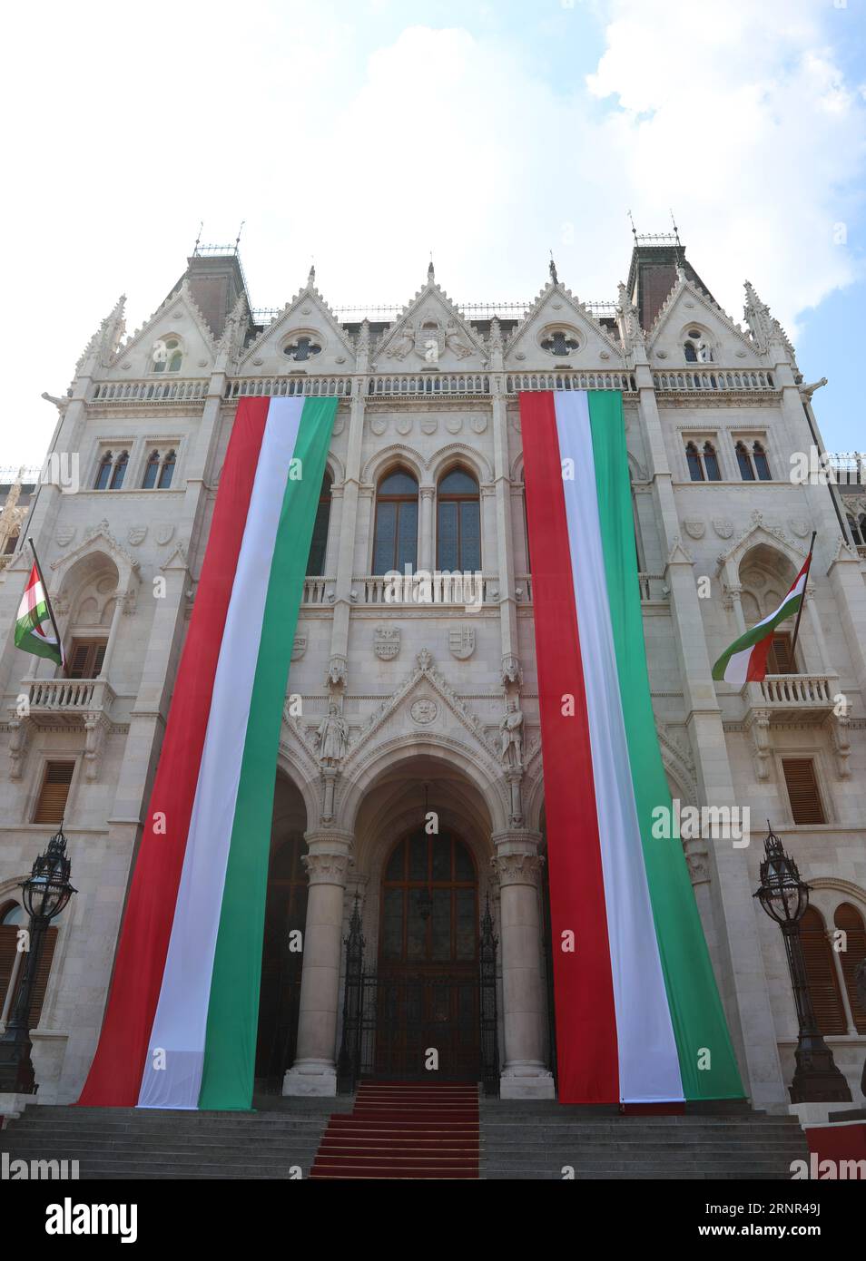 Budapest, B, Hungary - August 20, 2023: Hungarian Parliament building and big flags during the ...