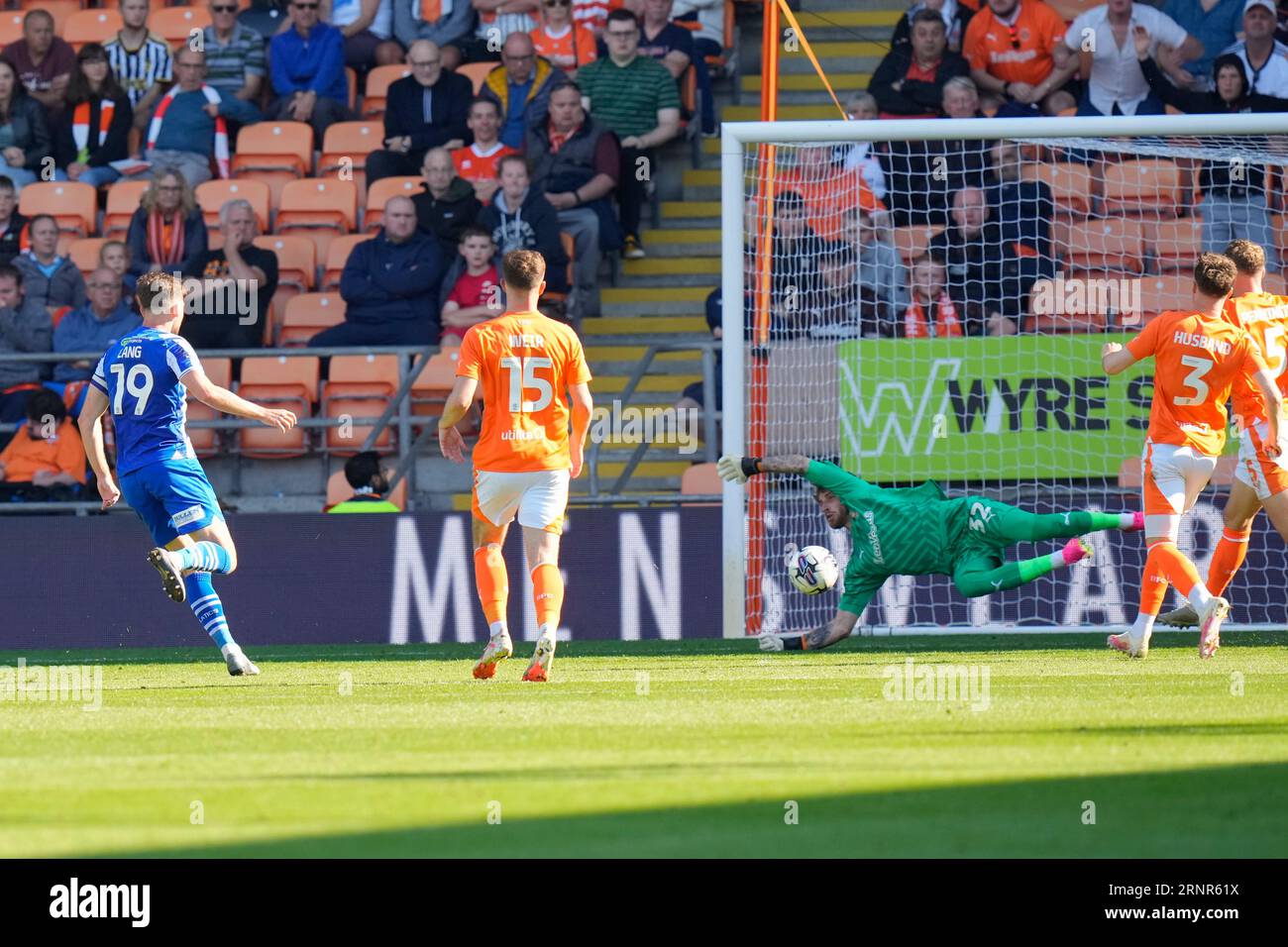 Daniel Grimshaw #32 of Blackpool saves a shot from Callum Lang #19 of ...