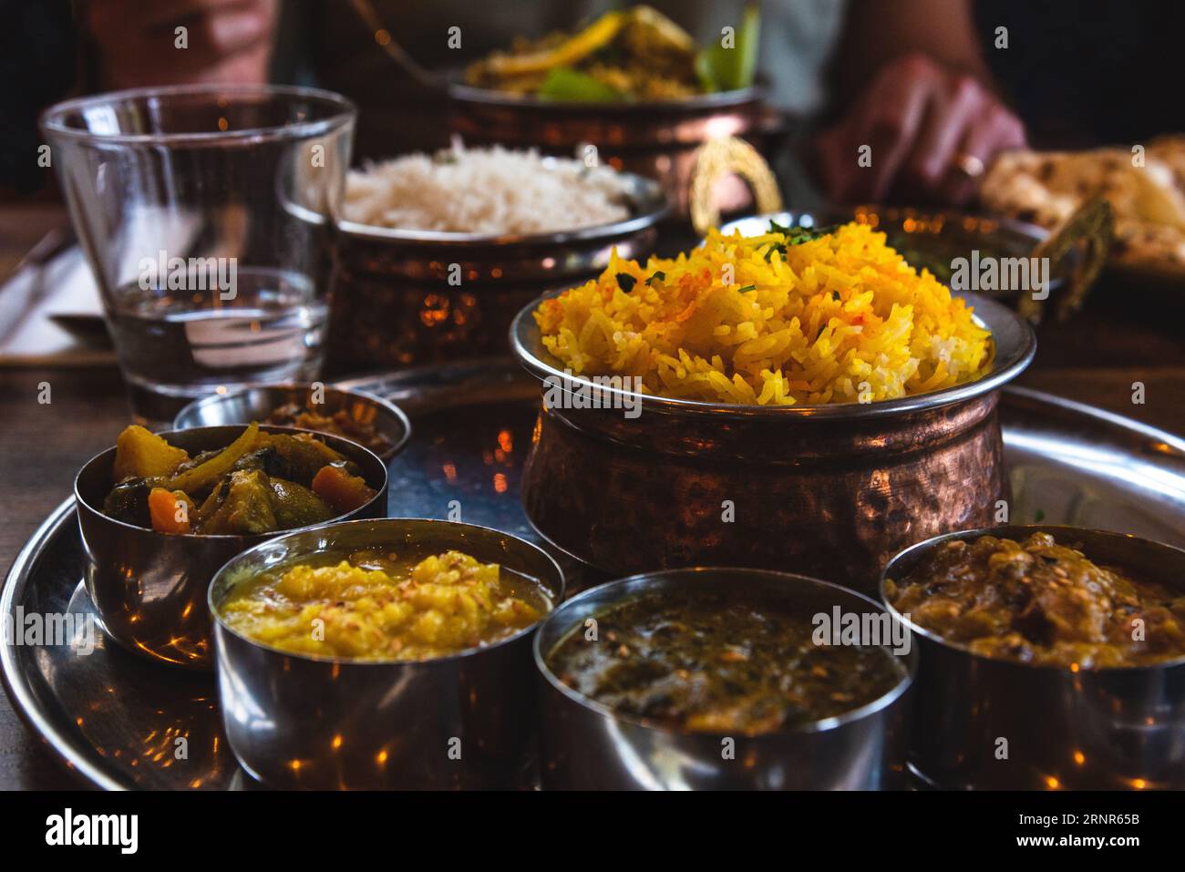Man eating traditional food in an Indian restaurant. Vegetarian Thali ...