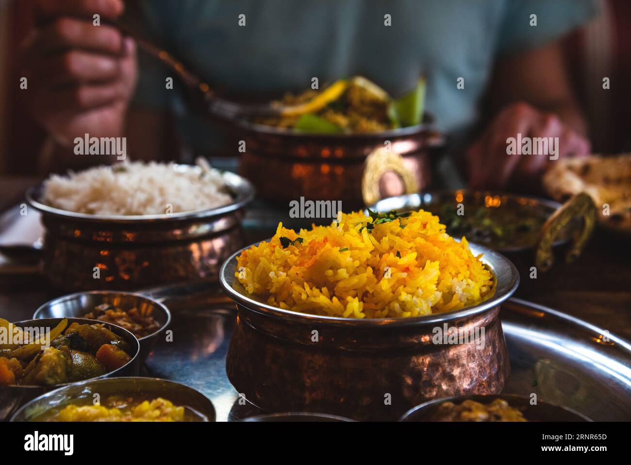 Man eating traditional food in an Indian restaurant. Vegetarian Thali ...