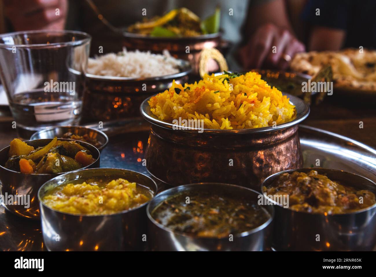Man eating traditional food in an Indian restaurant. Vegetarian Thali ...
