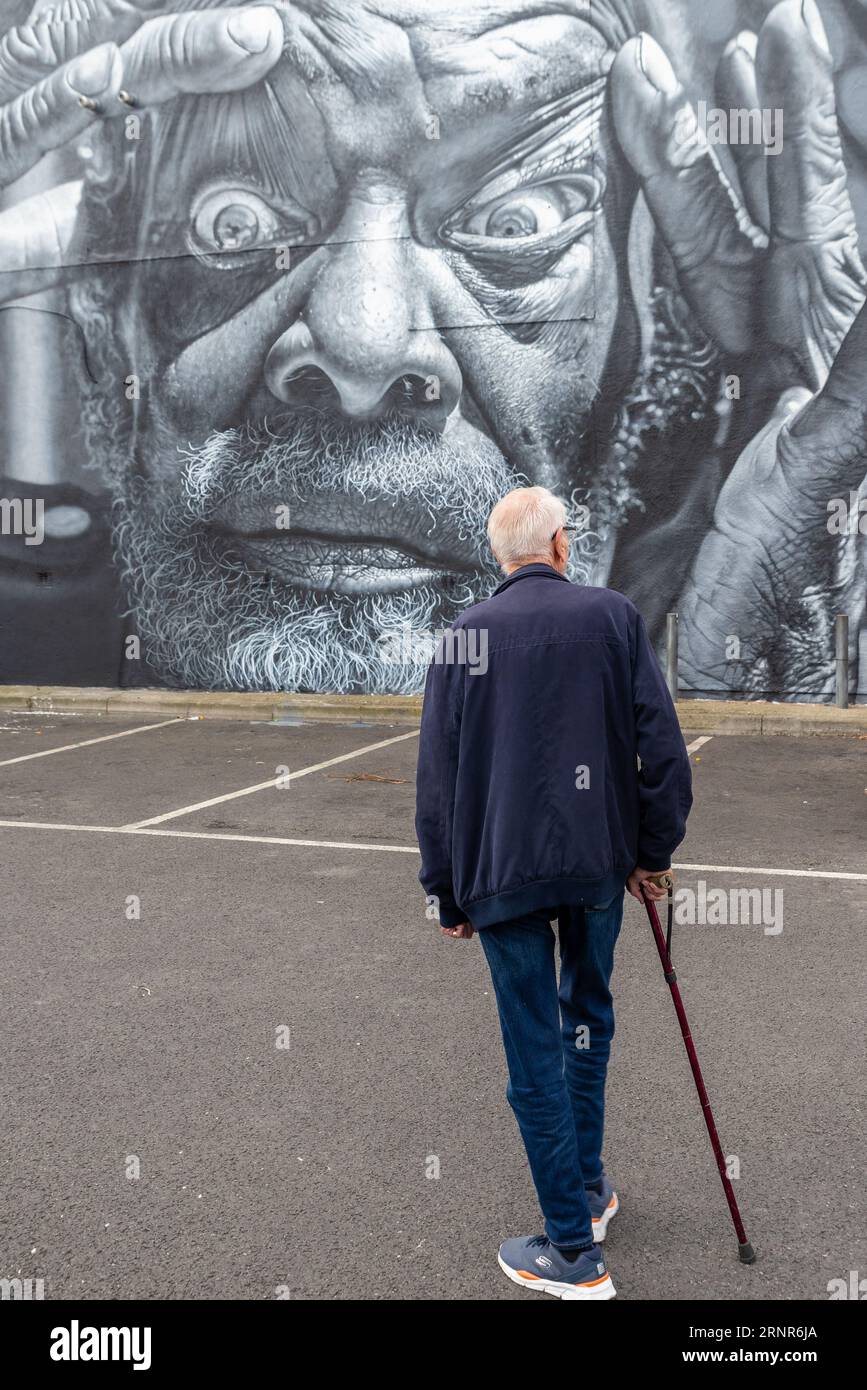 Senior male viewing large artwork by JEKS as part of the Southend City ...