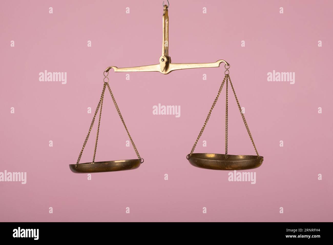 man hand holding a balance on pink background Stock Photo - Alamy